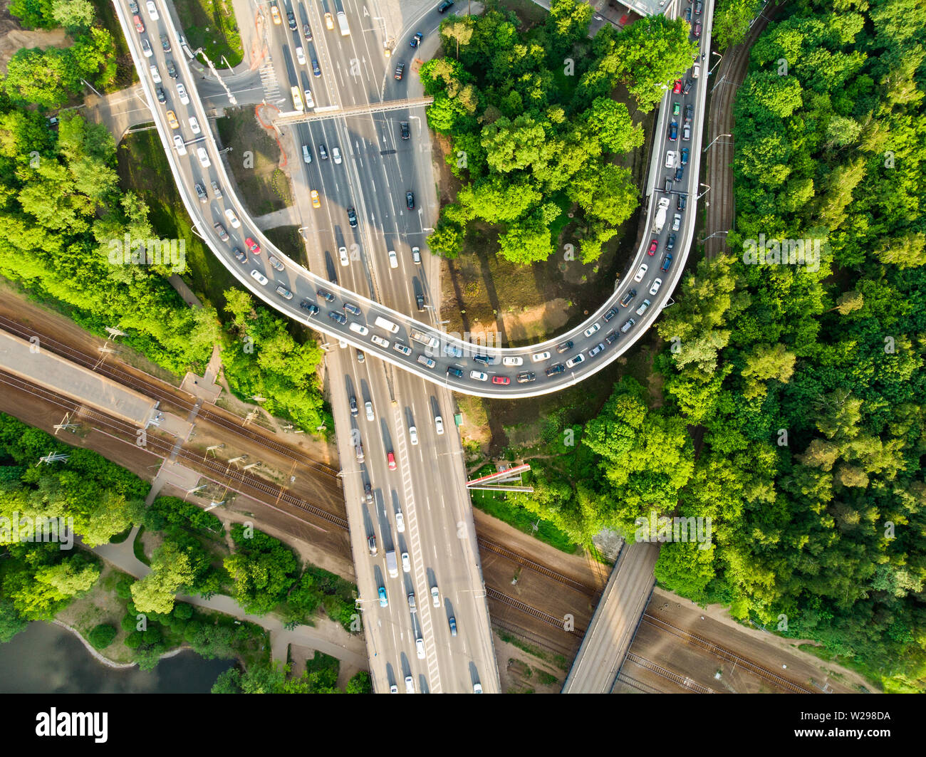 Photo on top of road with cars standing in traffic jams, green forest ...