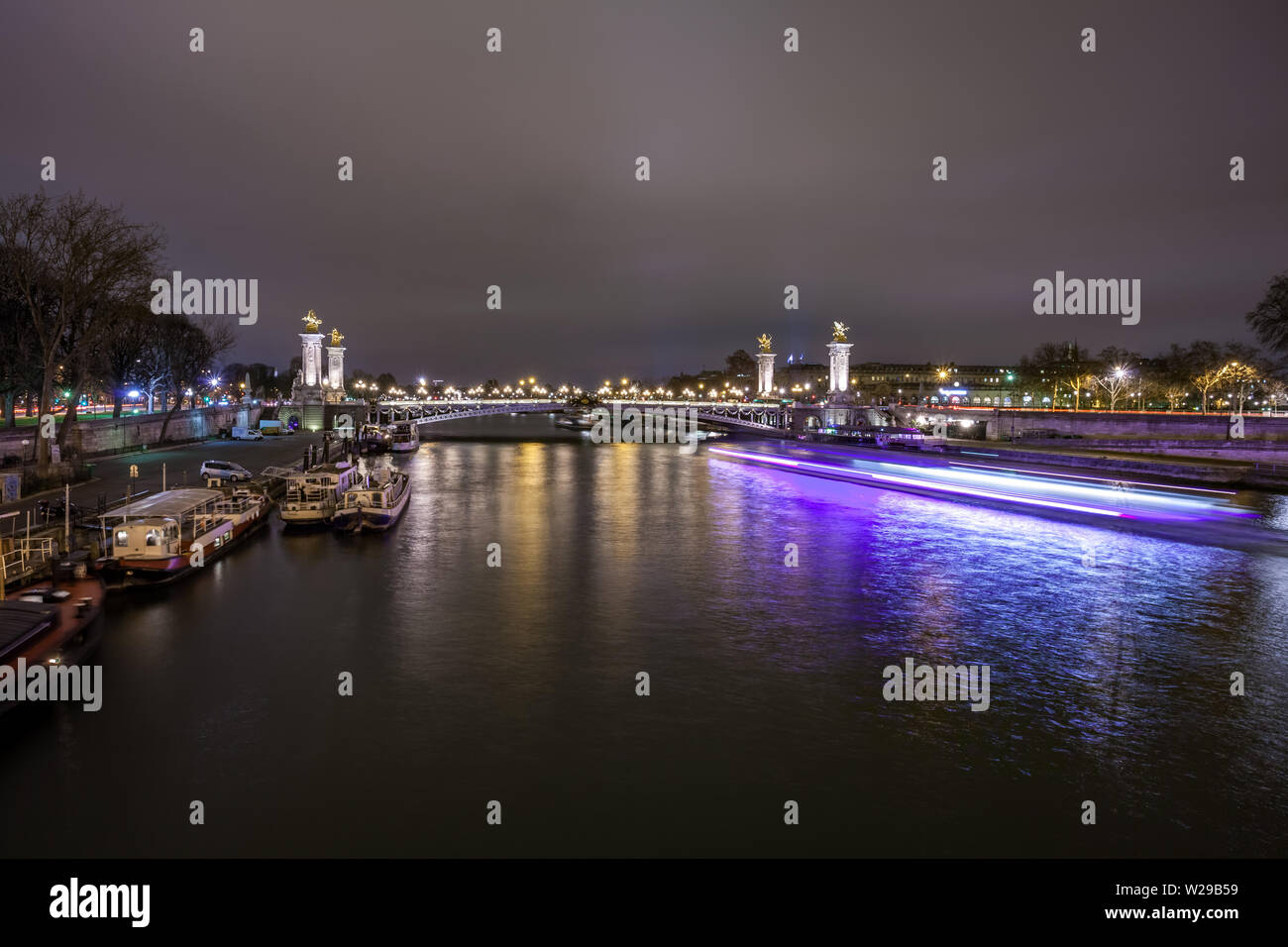 Pont Alexandre III in Paris at night. This bridge is one of the most ...