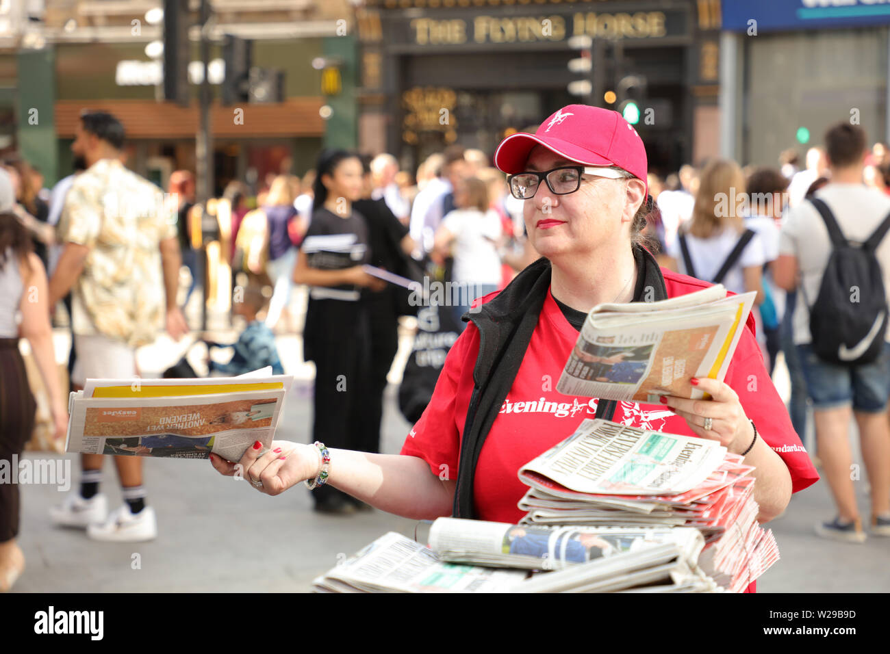 One woman handing out newspapers hi-res stock photography and images ...