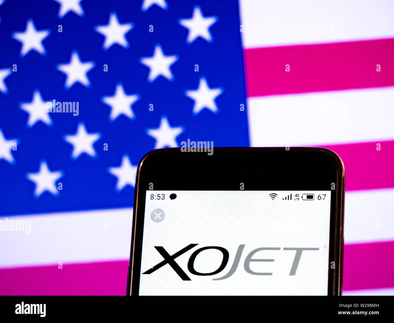 In this photo illustration the XOJET logo is seen displayed on a ...