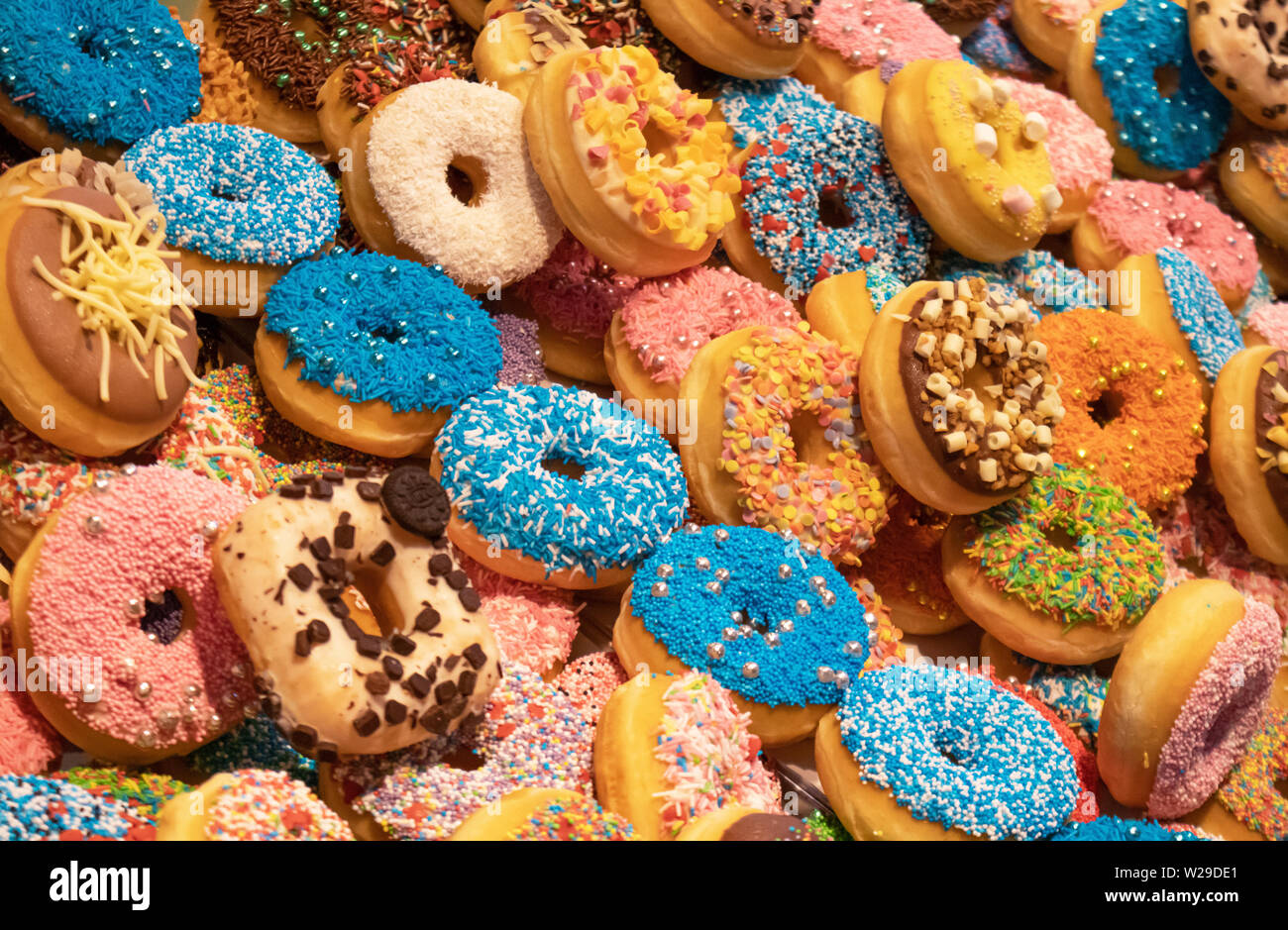 Assorted donuts, bakery display. Colorful donuts assortment background ...