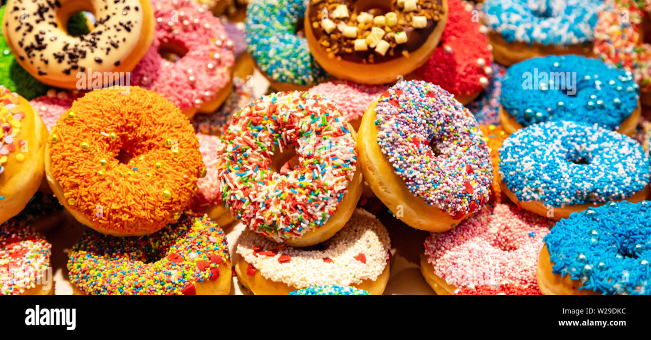 Assorted donuts, bakery display. Colorful donuts assortment background ...