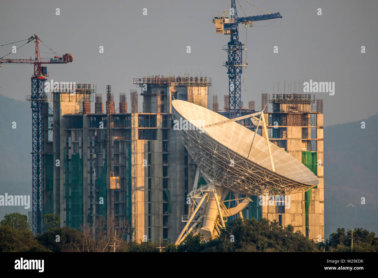 Large satellite dish on the building onstruction background Stock Photo ...