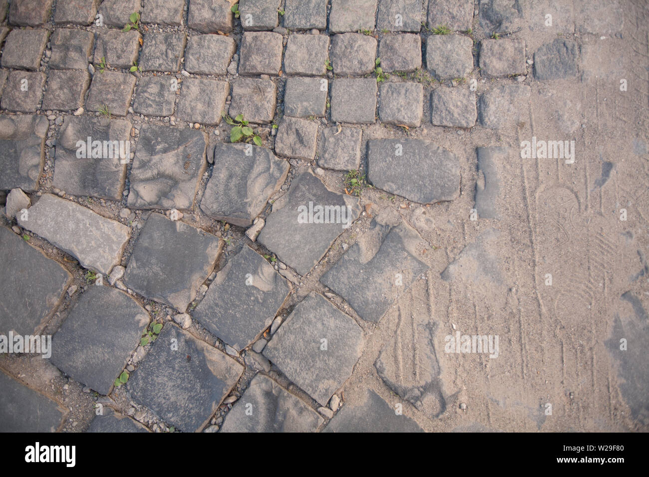 old vintage cobbled road texture background Stock Photo - Alamy