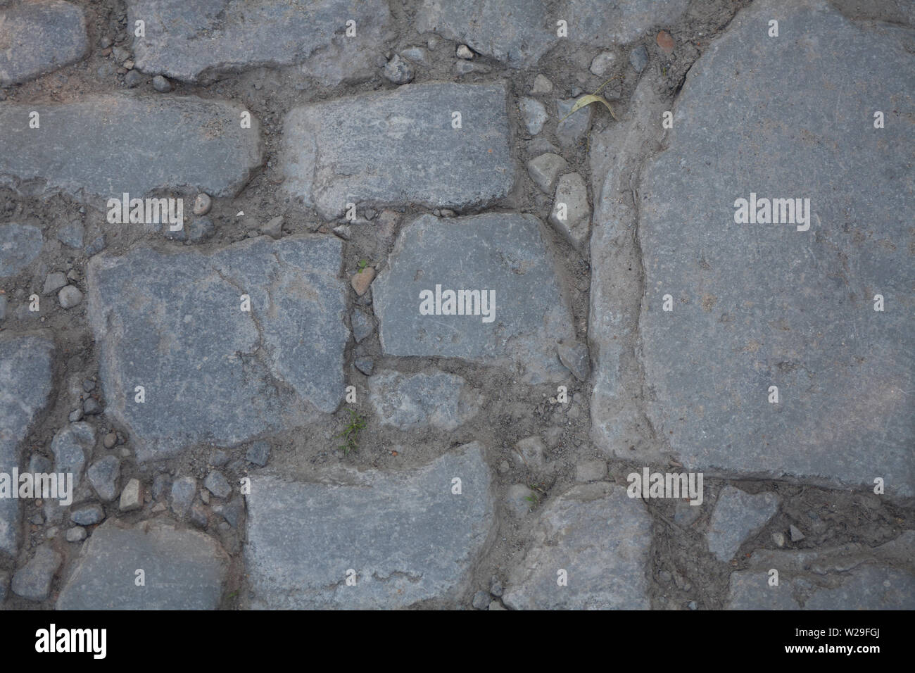 old vintage cobbled road texture background Stock Photo - Alamy