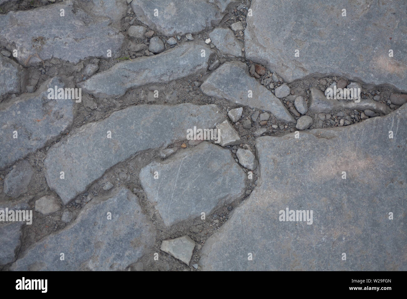 old vintage cobbled road texture background Stock Photo - Alamy