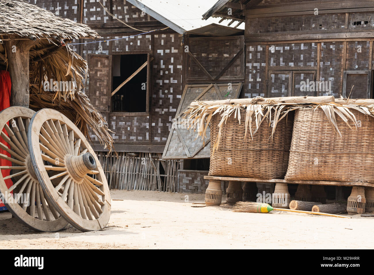 Rustic village farm backyard with bamboo hut, baskets and two wooden ...