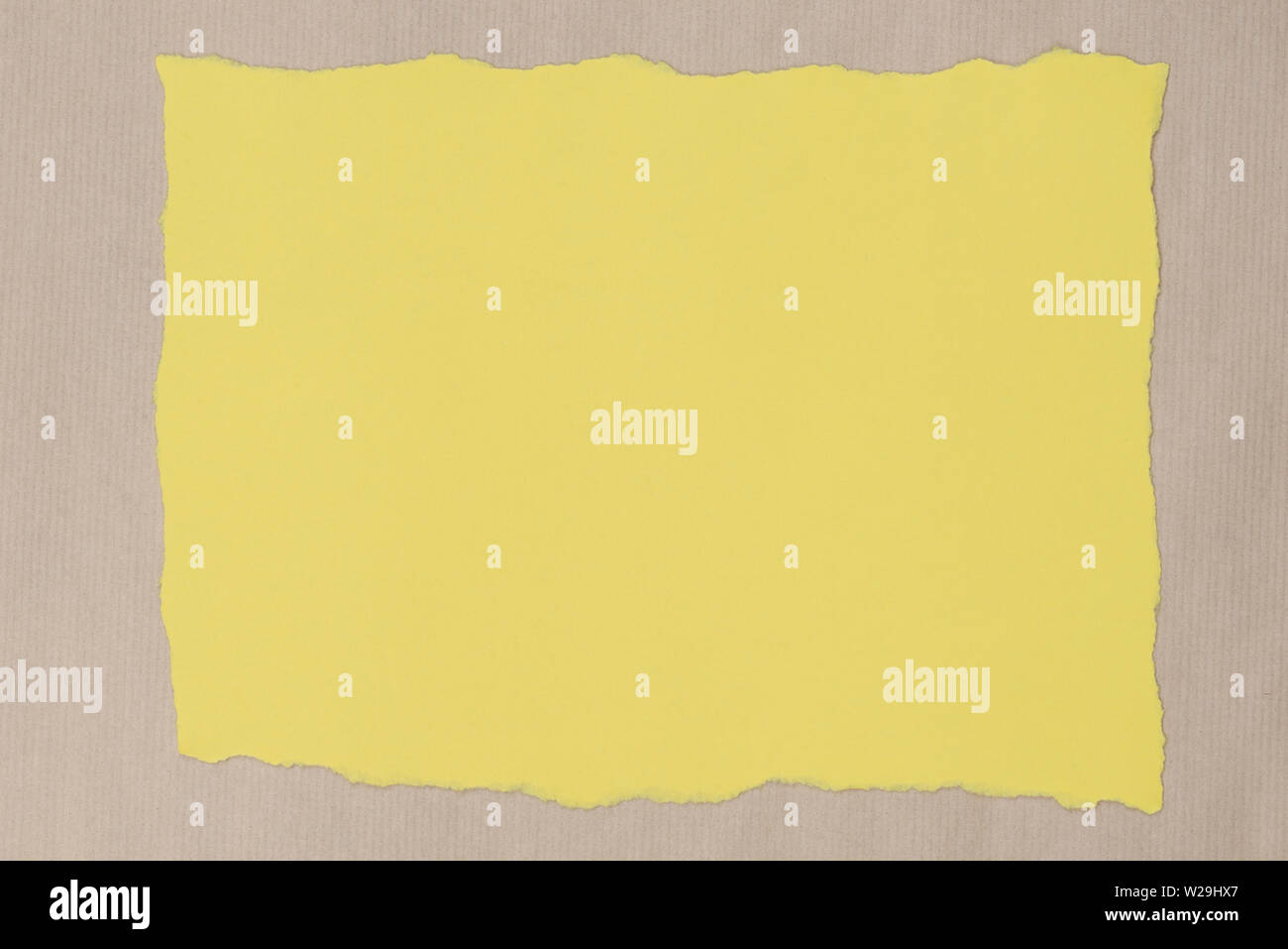 yellow color piece of torn paper on recycled paper background texture ...