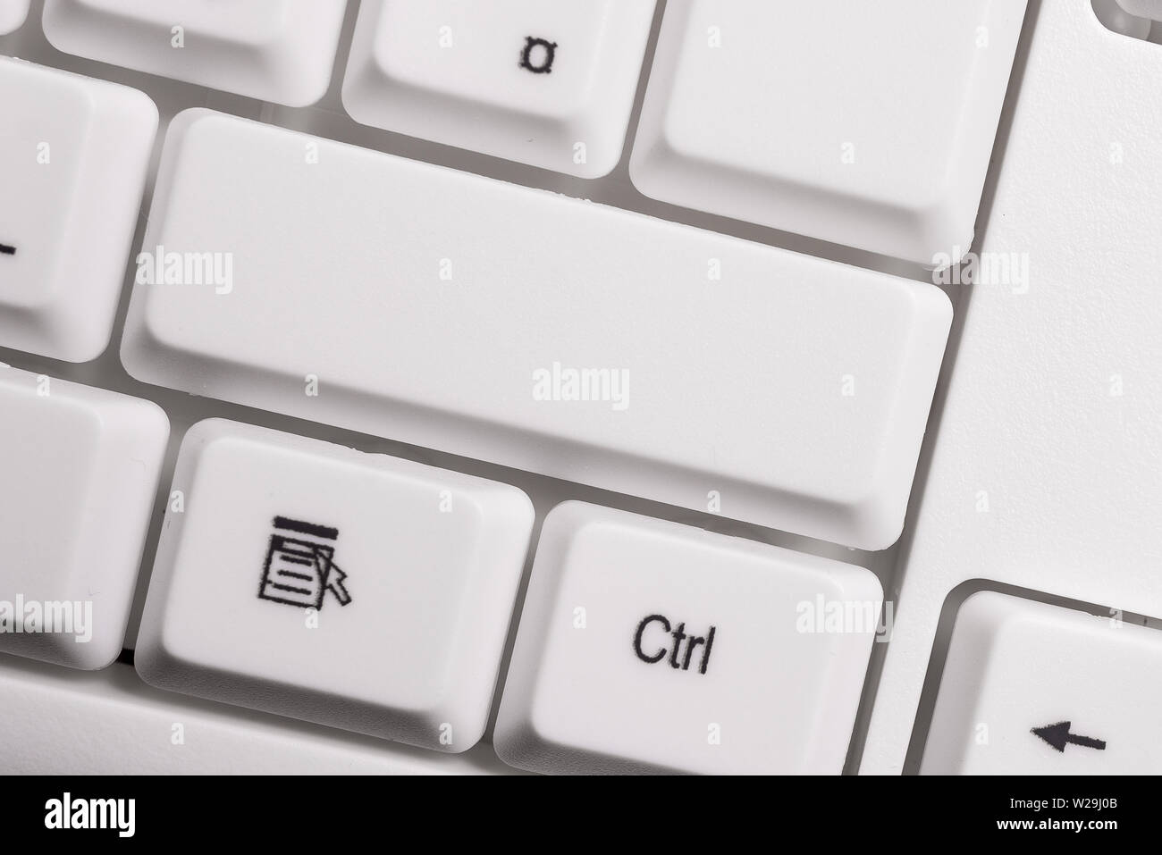 White pc keyboard with empty note paper above white background key copy ...