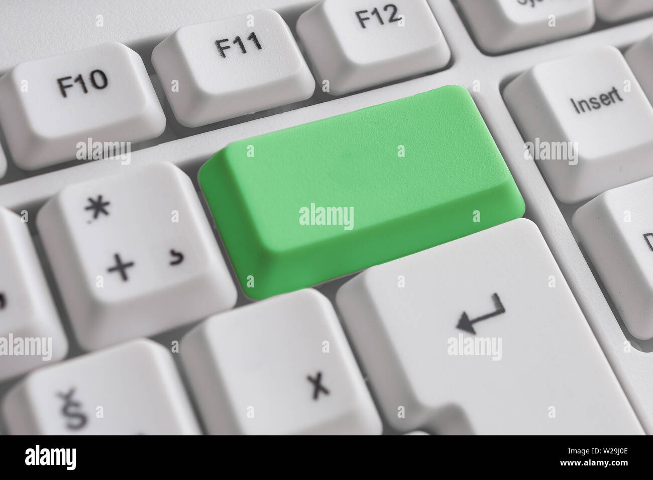 White pc keyboard with empty note paper above white background key copy ...