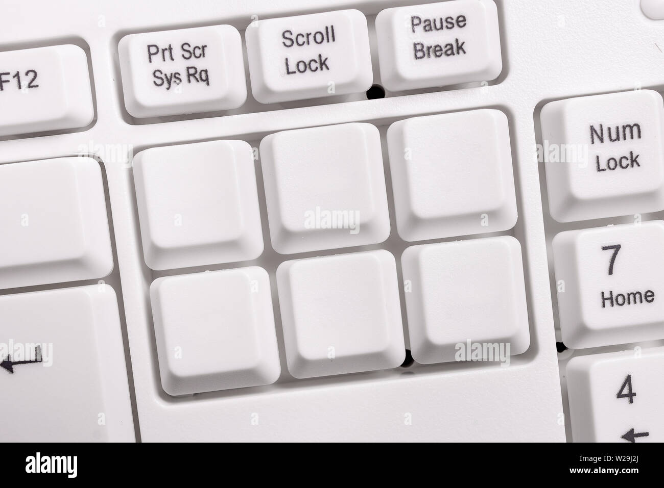 White pc keyboard with empty note paper above white background key copy ...