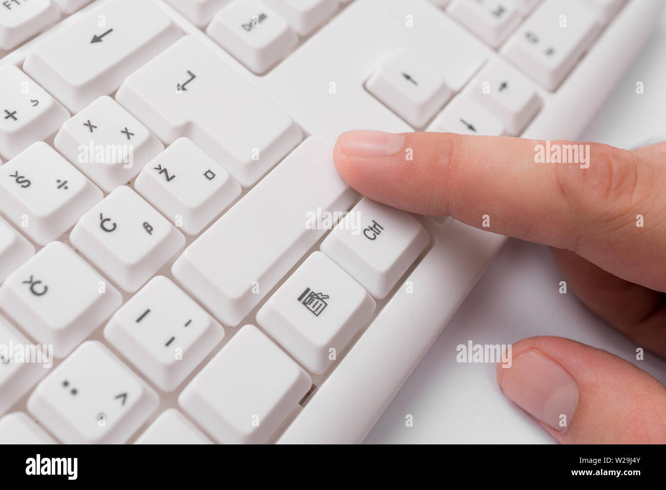 White pc keyboard with empty note paper above white background key copy ...
