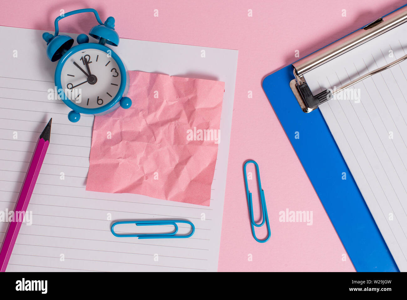 Paper sheet note clipboard pencil clips alarm clock colored background ...