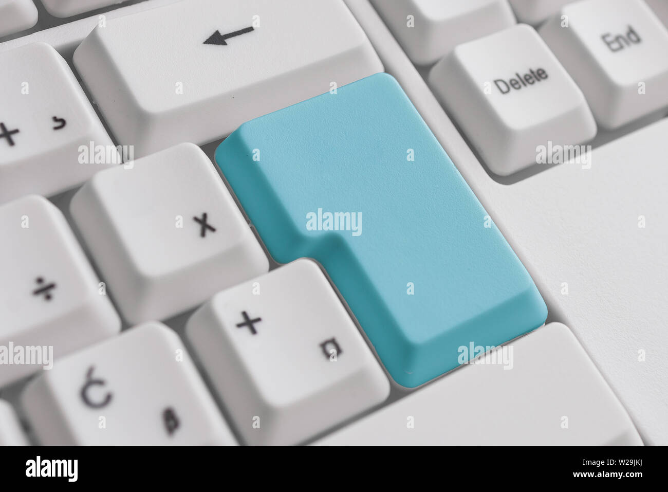 White pc keyboard with empty note paper above white background key copy ...
