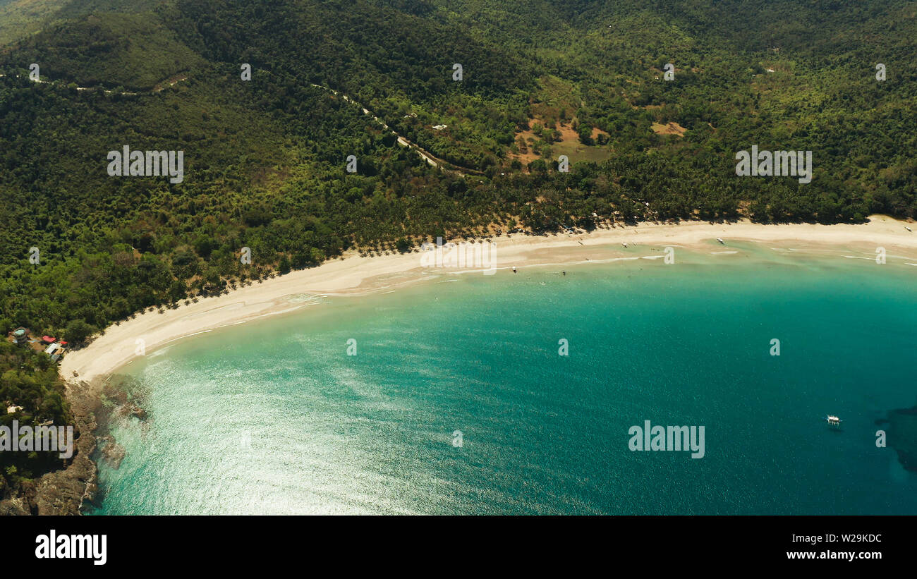 Aerial drone of beautiful tropical beach in cove with blue lagoon and ...