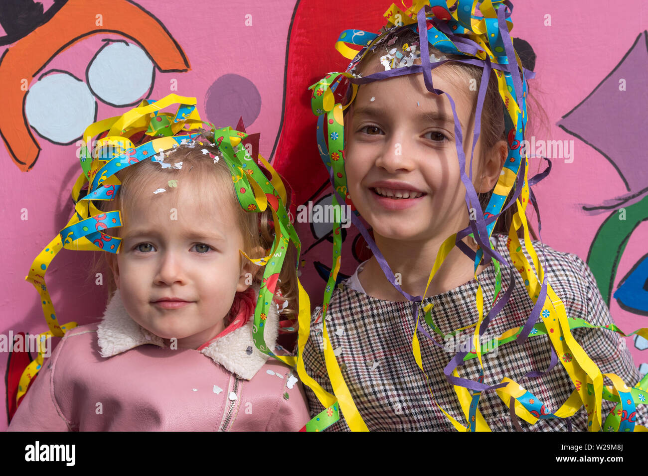 Sisters playing at a carnival celebration Stock Photo - Alamy