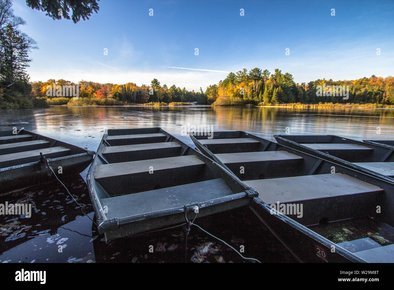 Rowboat Docked On Lake. Rowboats at wooden dock waiting for tourists at ...