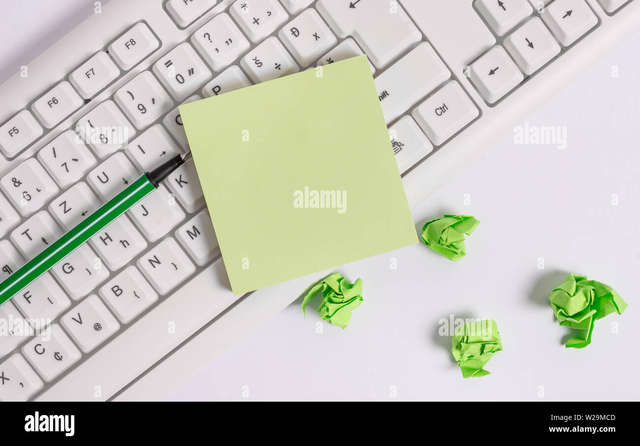 Square empty green note paper with pencil on the white background and ...