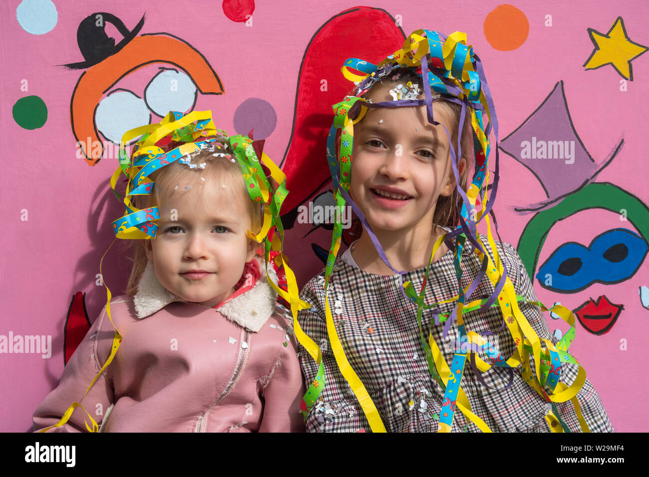 Sisters playing at a carnival celebration Stock Photo - Alamy