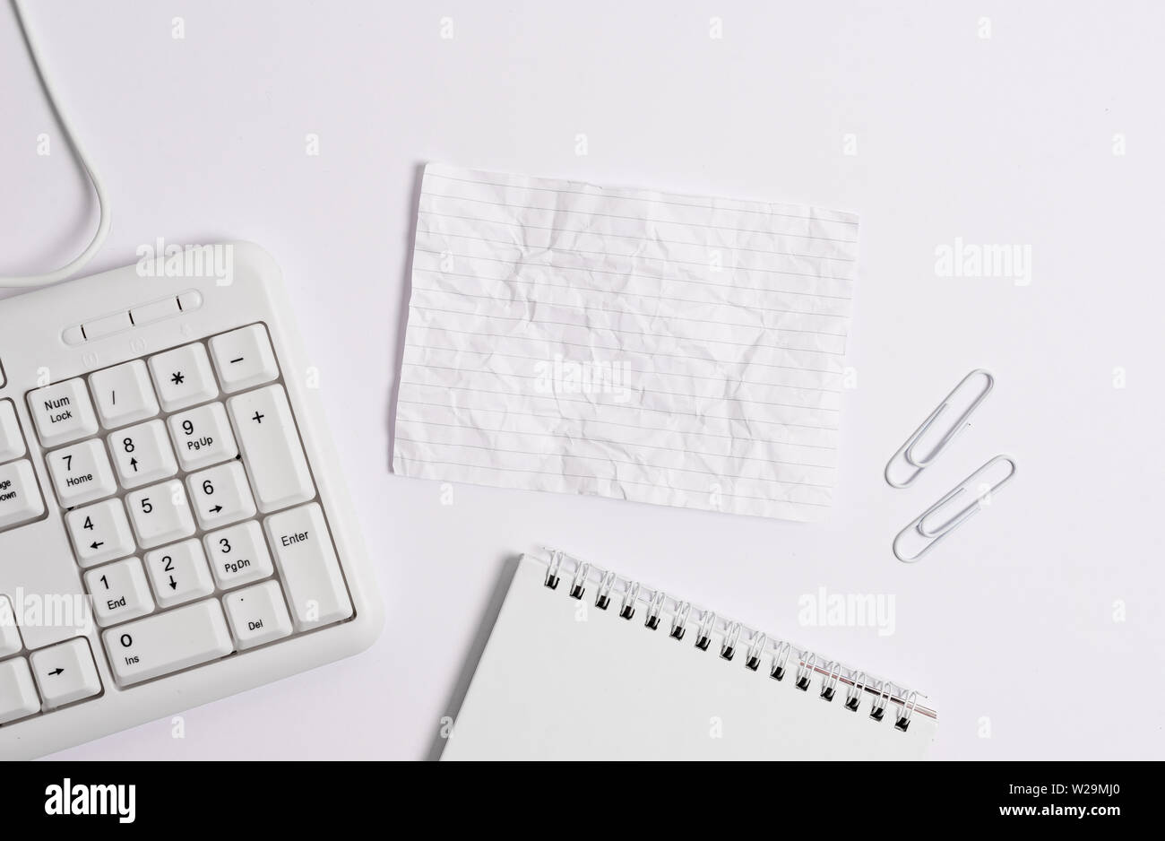 White pc keyboard with empty note paper above white background Stock ...