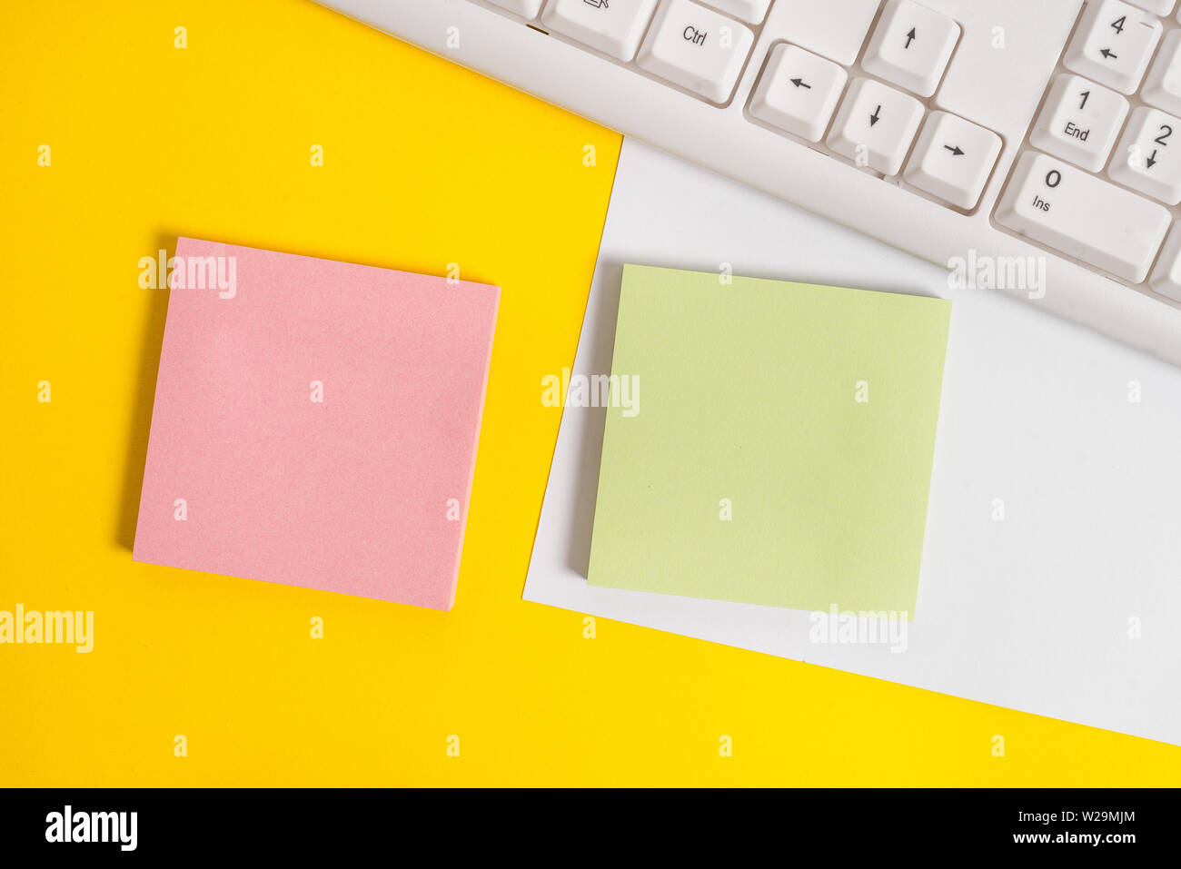 Empty blank paper with copy space and pc keyboard above orange ...