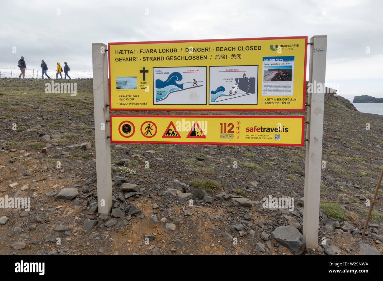 Sign warning that the beach below is closed with emergency contact ...
