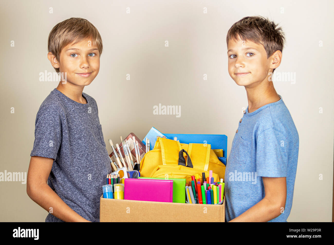 Donation concept. Kids holding donate box with books and school ...