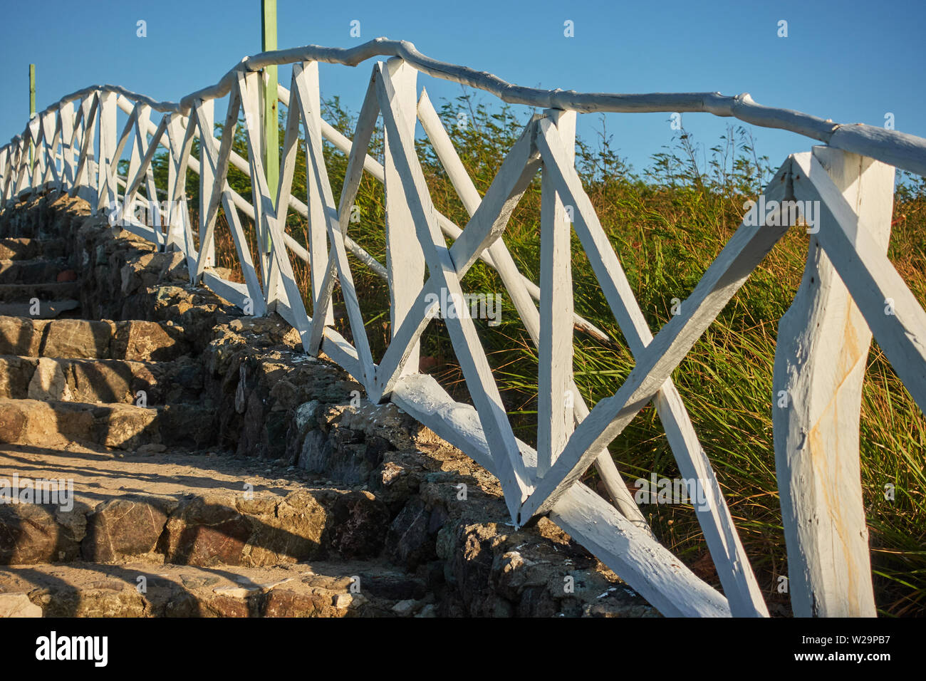 Tourist path with steps and white fence leading up Stock Photo - Alamy