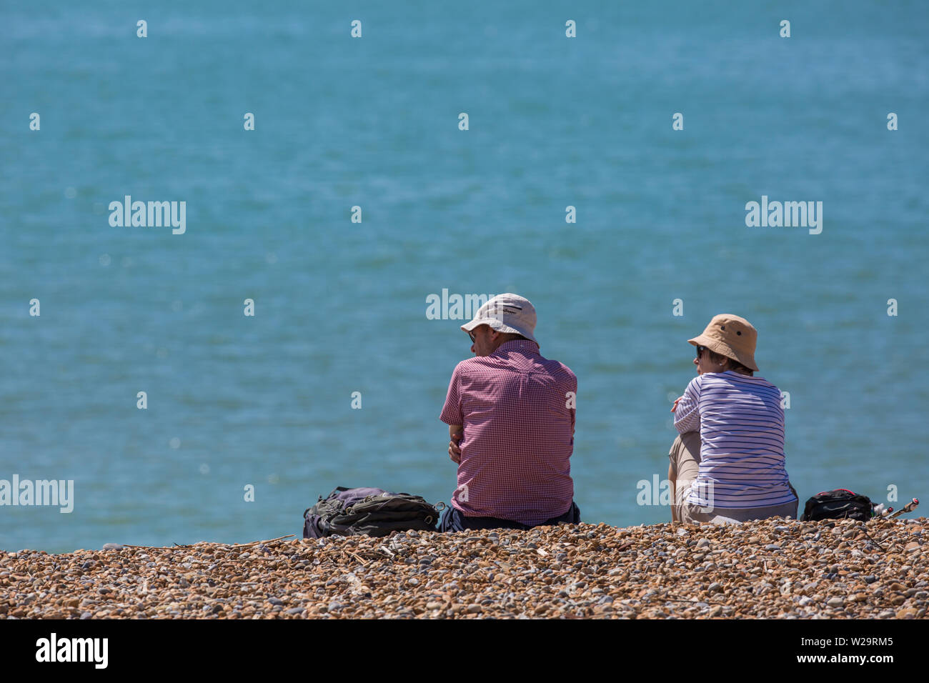 Enjoying the sun and view on an English beach Stock Photo - Alamy