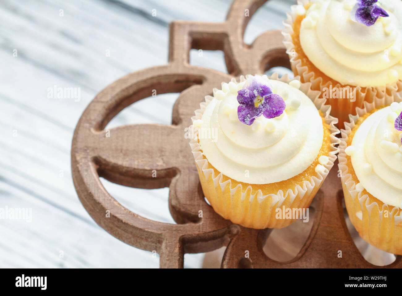 Beautiful vanilla cupcakes with buttercream icing decorated with sugar ...