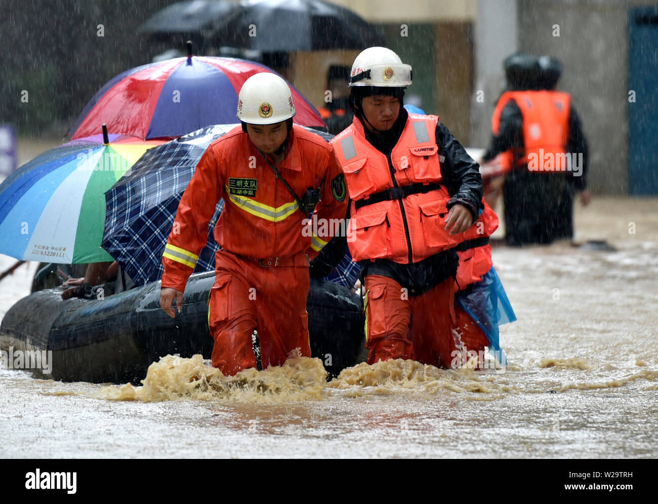 Fujian, China. 07th July, 2019. Firefighters rescue residents trapped ...