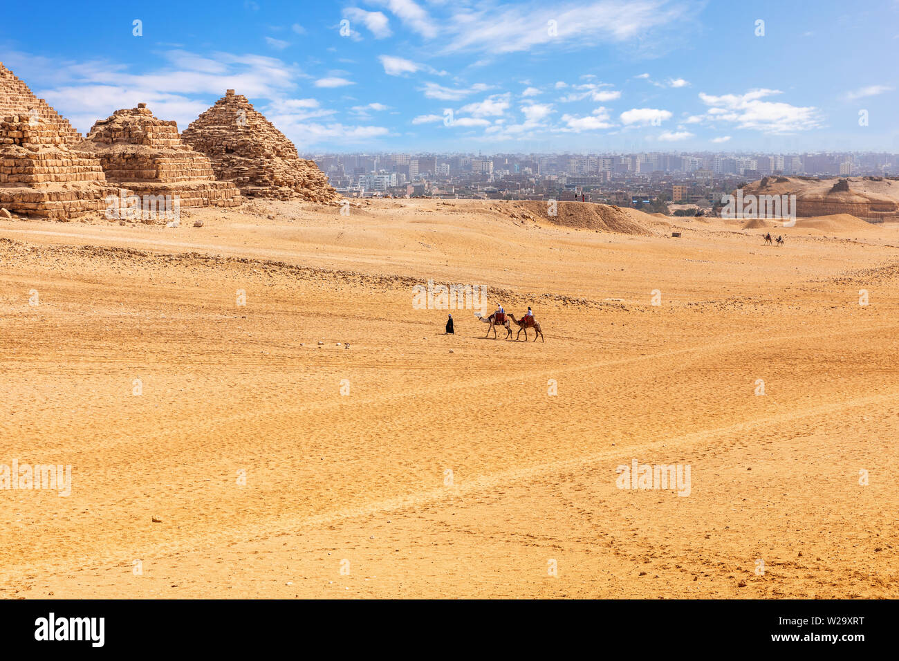 Small Pyramids of Menkaure queens and camels in Giza desert Stock Photo ...