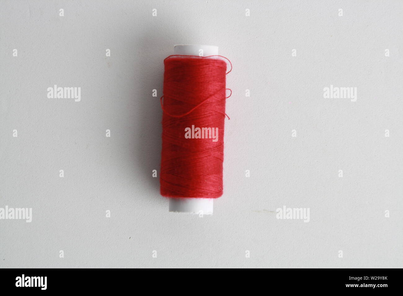 sewing thread red clothes Stock Photo - Alamy