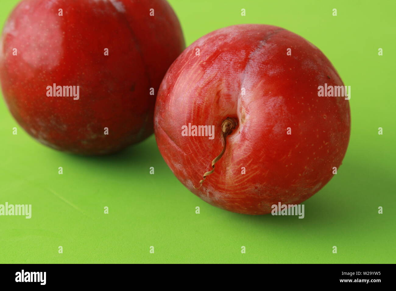 Delicious plums in colorful background Stock Photo - Alamy