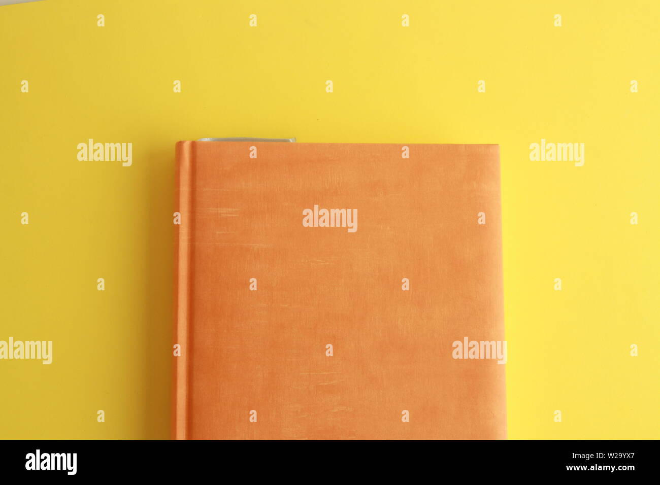 book with orange cover on colorful background Stock Photo - Alamy