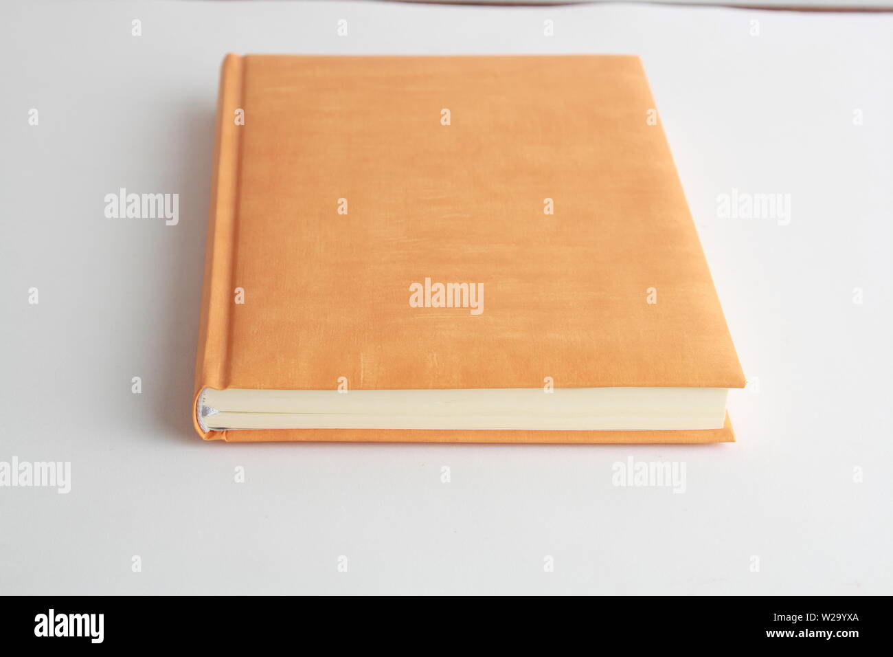 book with orange cover on colorful background Stock Photo - Alamy