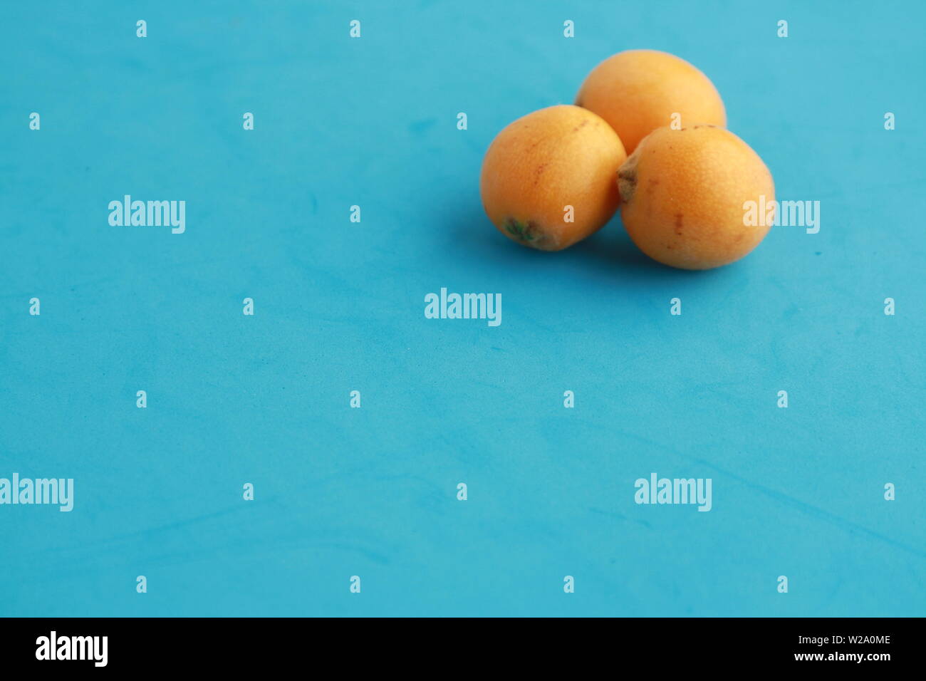 delicious yellow medlar fruit with colorful background Stock Photo - Alamy