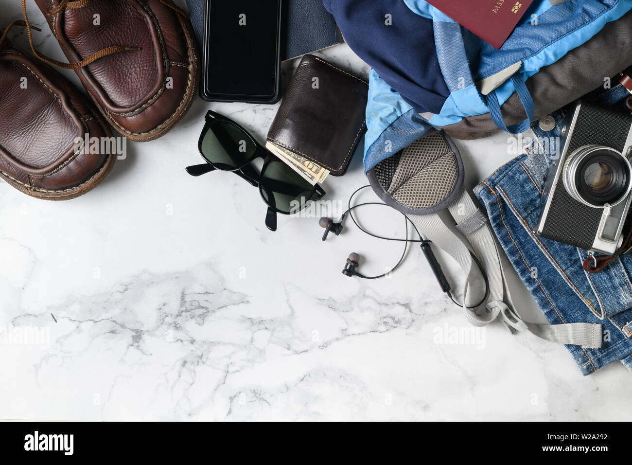prepare backpack accessories and travel items on marble background with ...