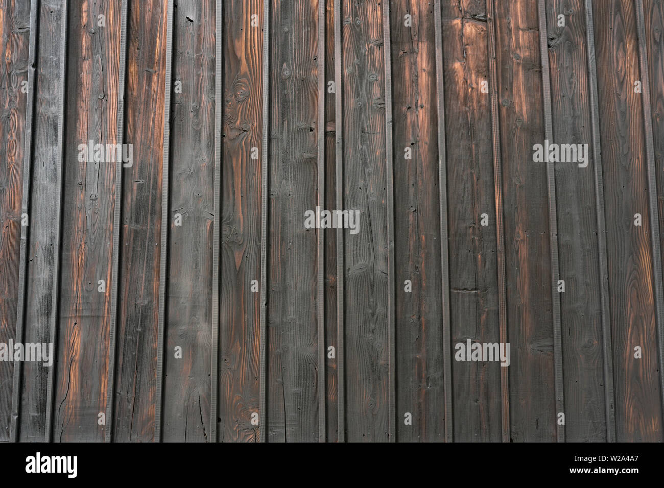 Natural dark stained wood building wall background Stock Photo - Alamy