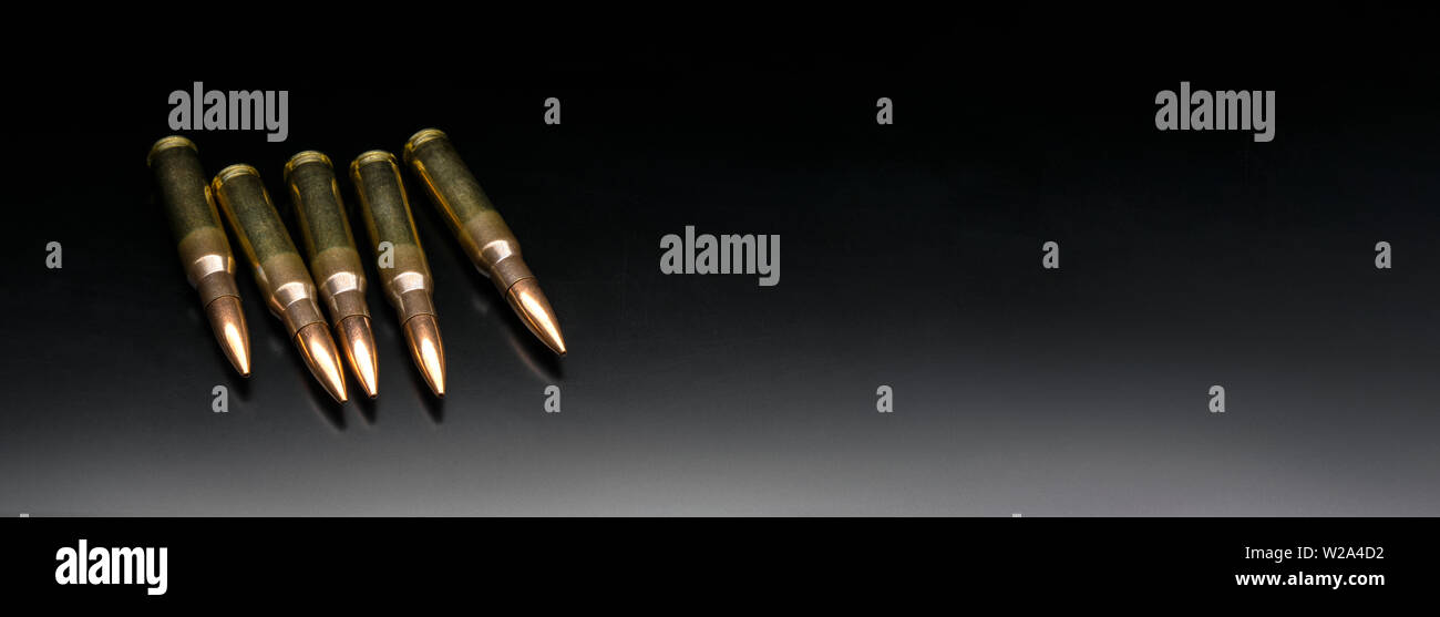 Bullet isolated on black background with reflexion. Rifle bullets close ...