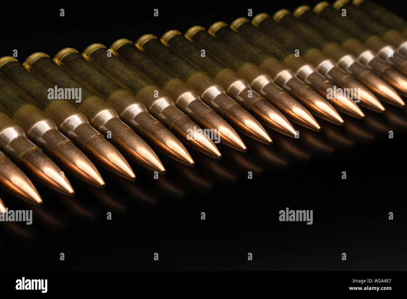 Bullet isolated on black background with reflexion. Rifle bullets close ...