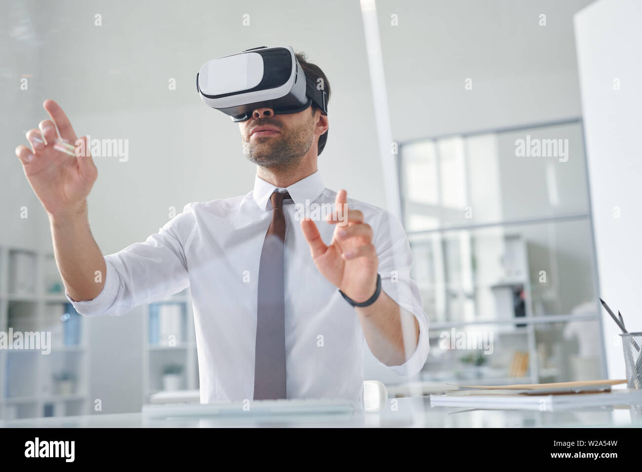 Contemporary young businessman making virtual presentation Stock Photo ...