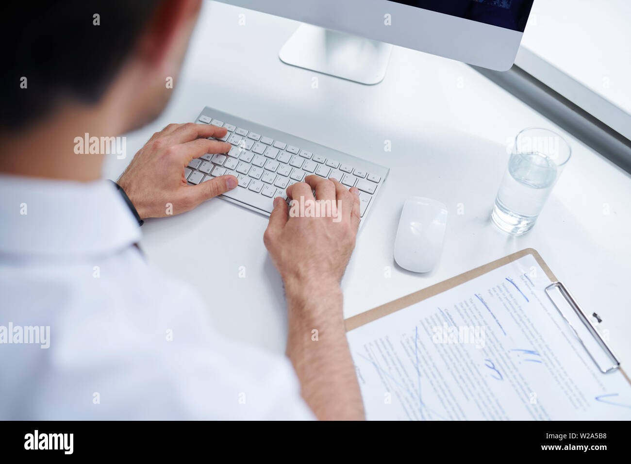 Hands of young analyst or broker touching keys of computer keypad Stock Photo - Alamy