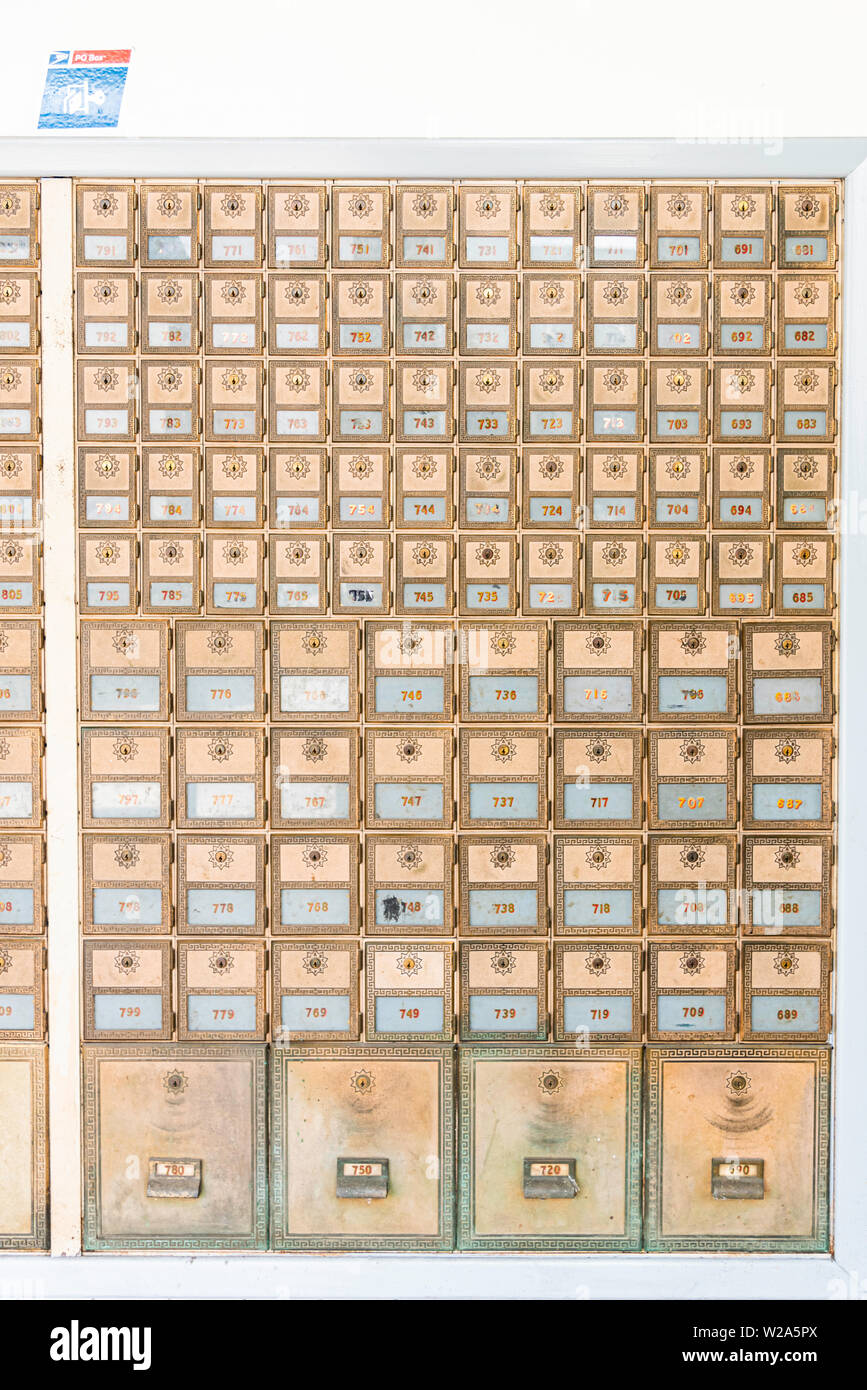 Rows of mid-century modern design post office mailboxes in brass metal ...