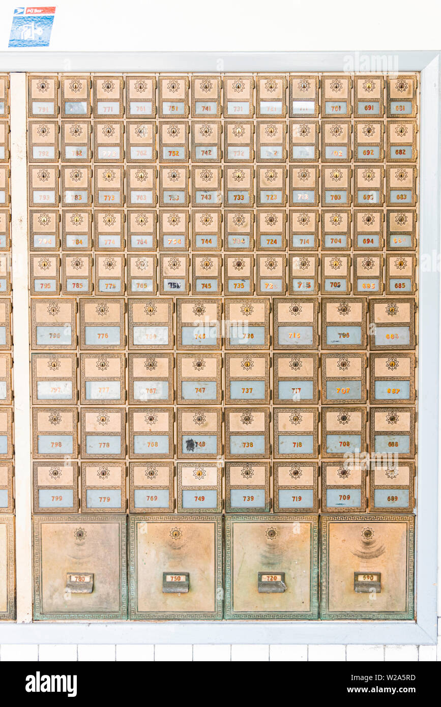 Rows of mid-century modern design post office mailboxes in brass metal ...