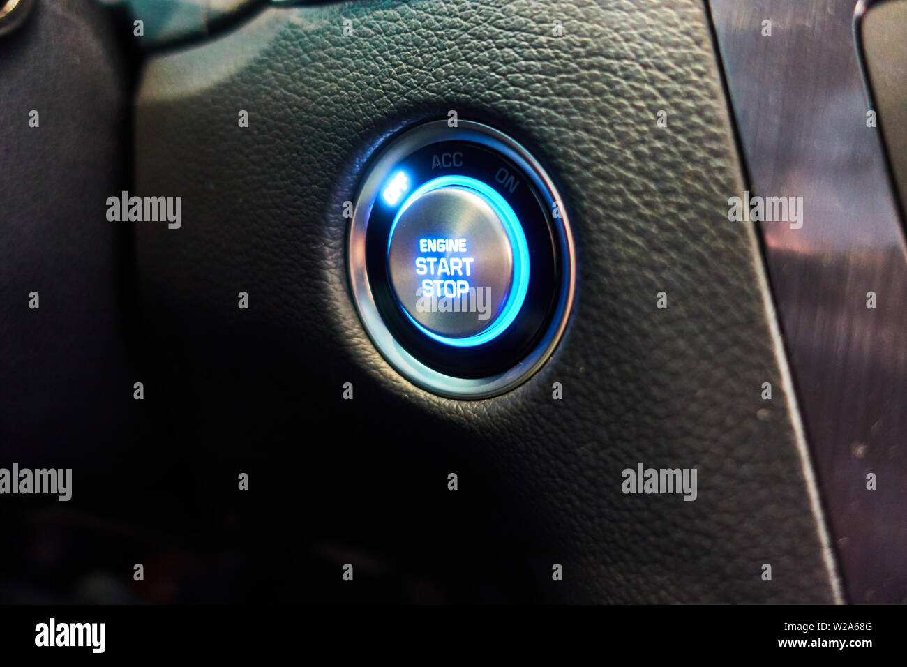 Car engine start button with blue backlight Stock Photo - Alamy