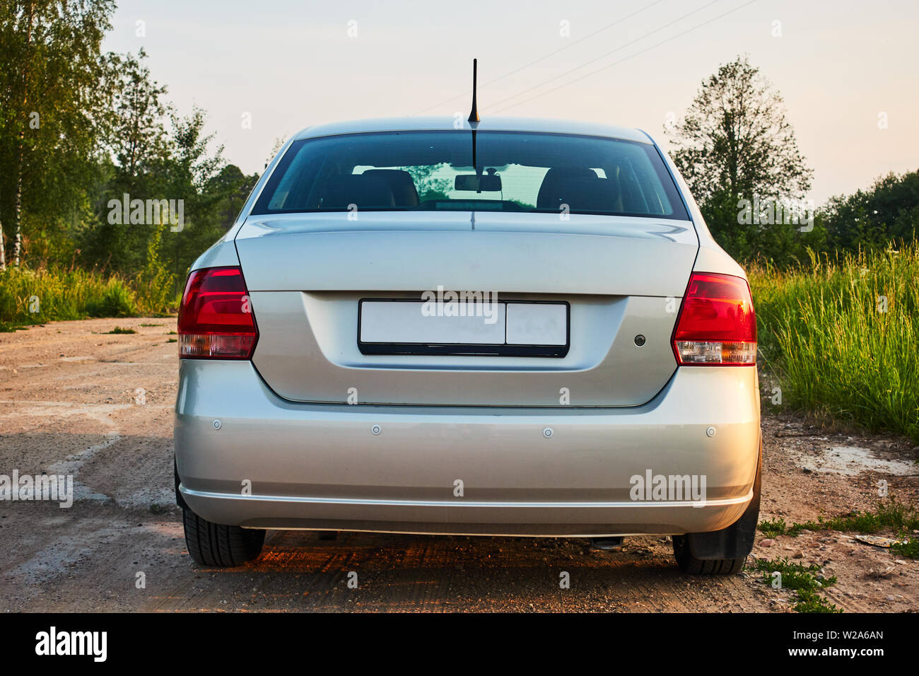 Car on a dirt road, rear view. Travelling by car Stock Photo - Alamy