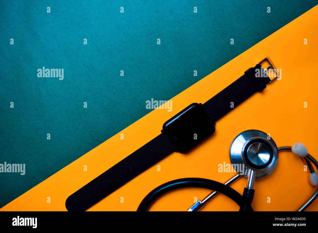 Smart watch and Stethoscope on top view color table and Healthcare ...