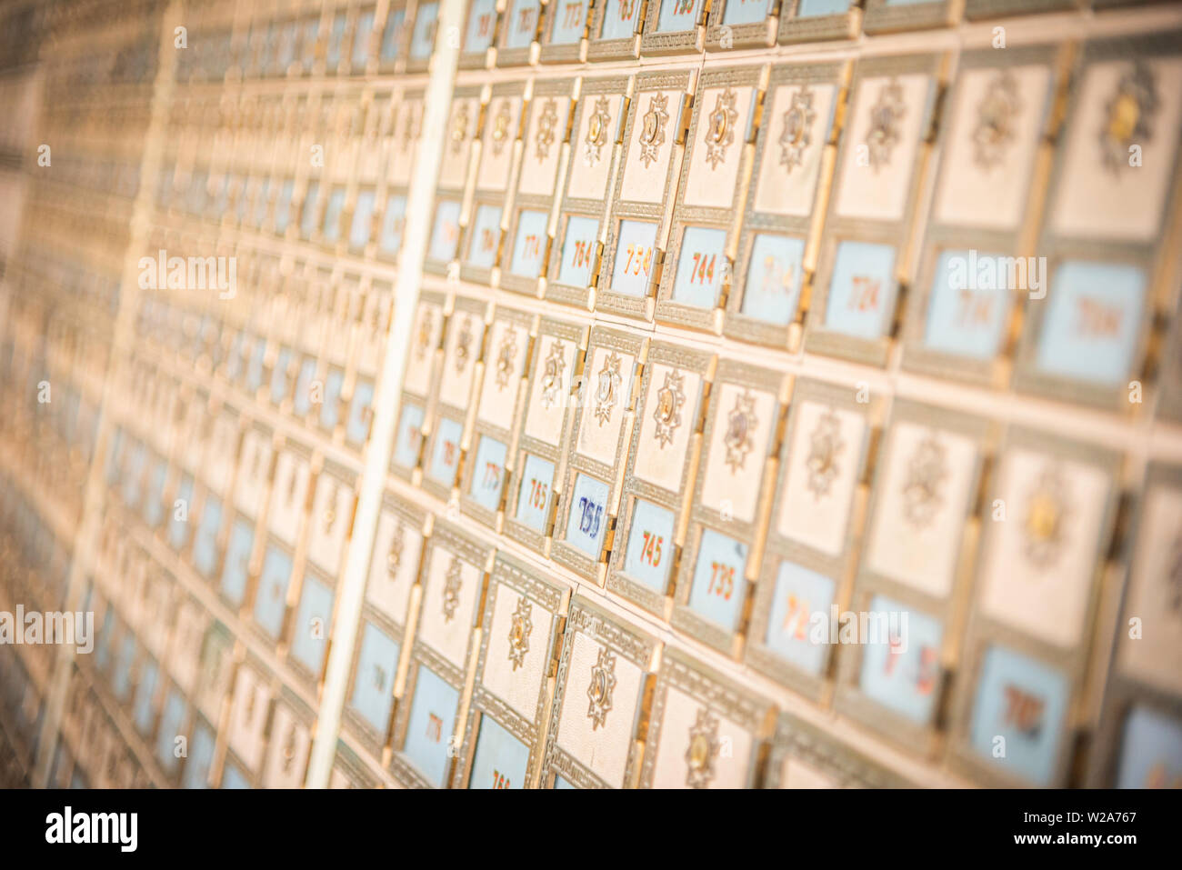 Rows of mid-century modern design post office mailboxes in brass metal ...