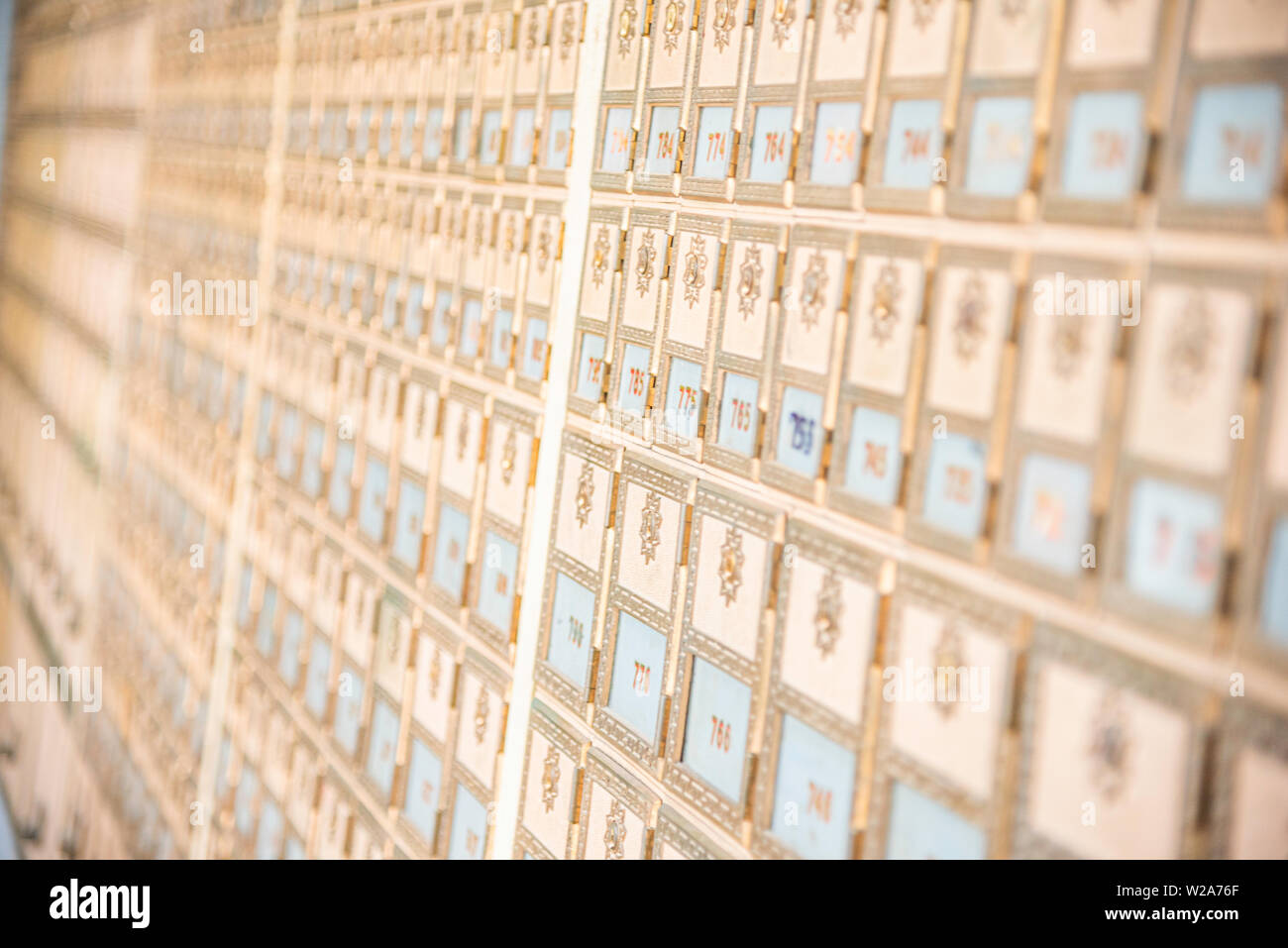 Rows of mid-century modern design post office mailboxes in brass metal ...